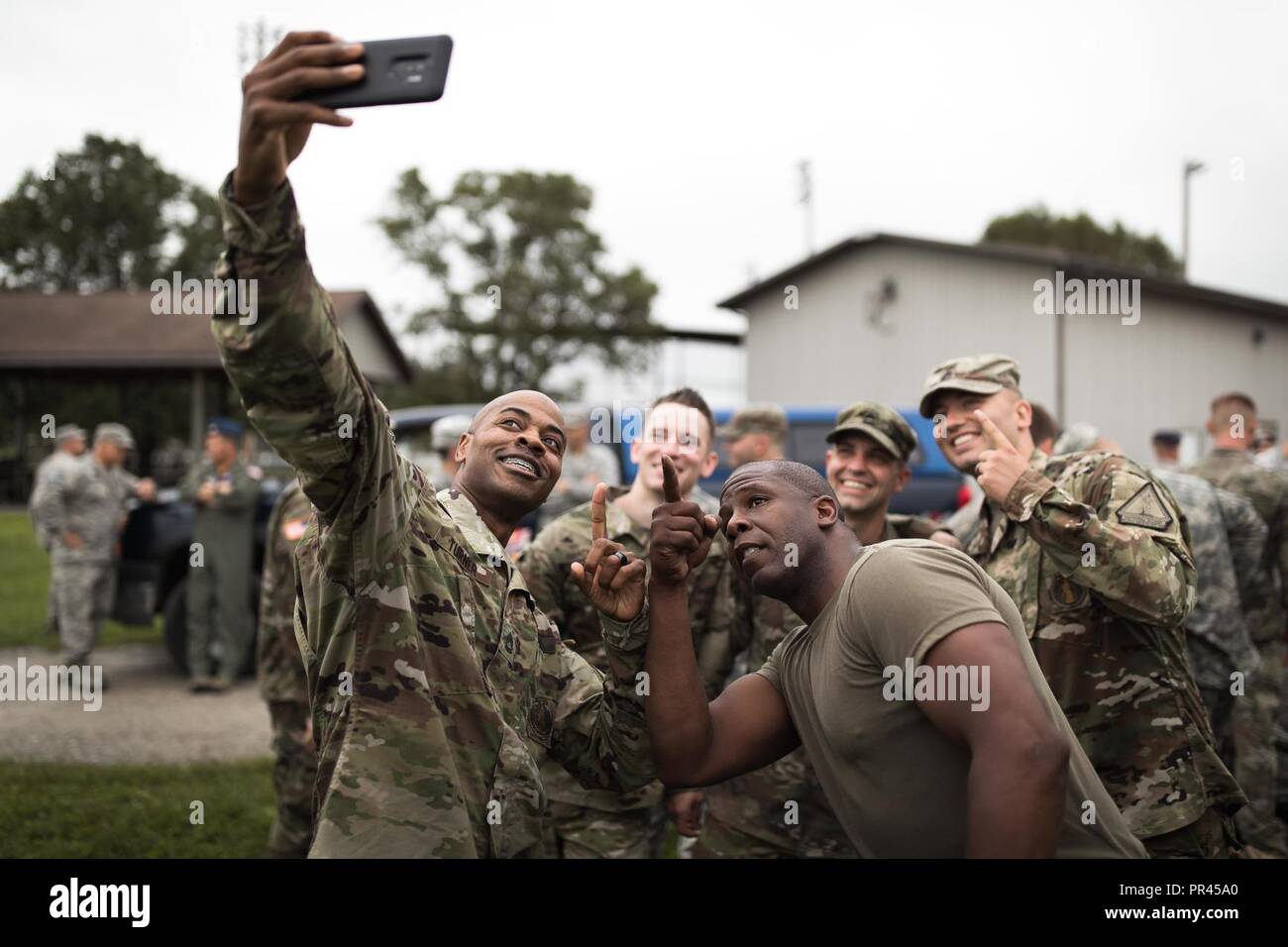 Servicemembers celebrate after finishing the ruck march portion of the ...