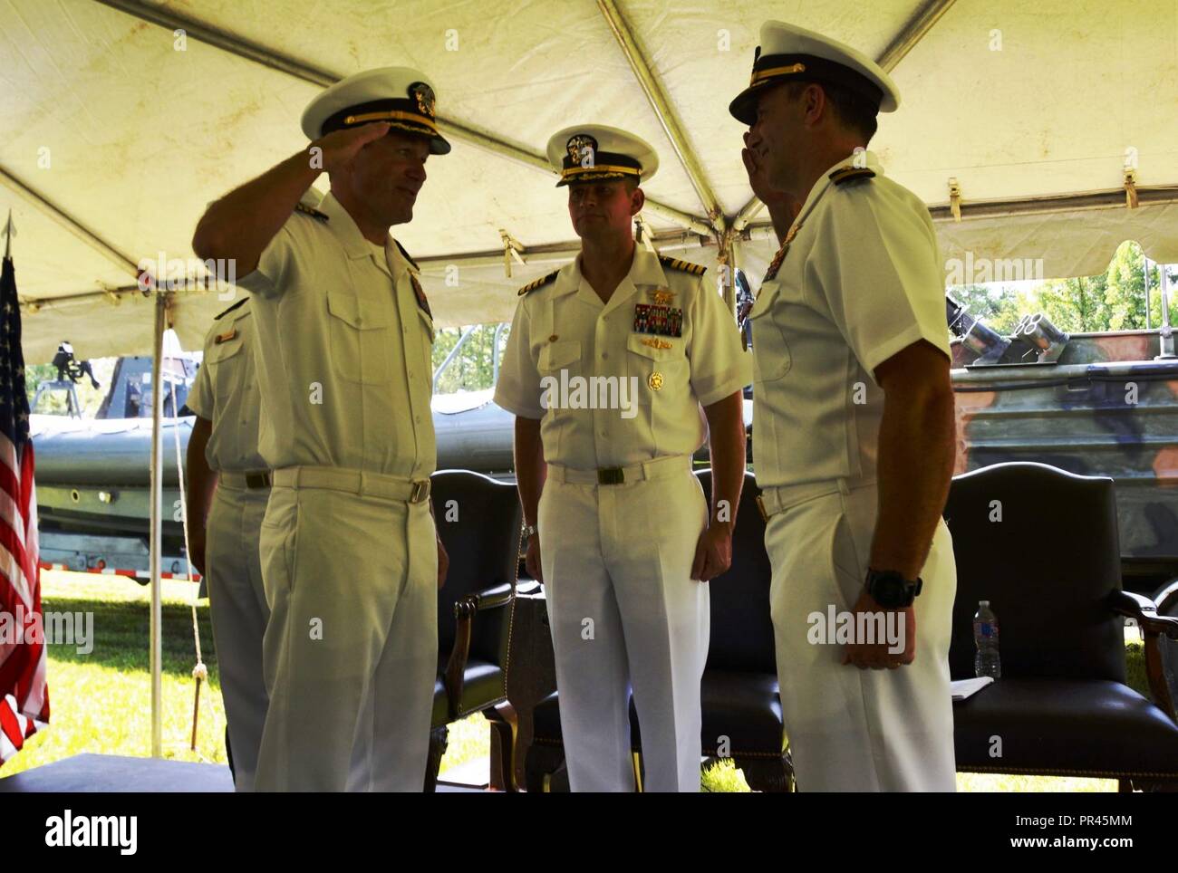 Incoming Special Boat Team 22 Cmdr. Kurt J. Muhler salutes outgoing ...