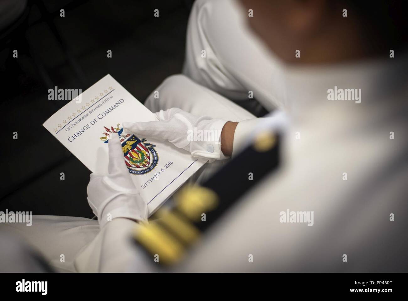 SAN DIEGO (Sept. 6, 2018) A guest holds a change of command pamphlet ...