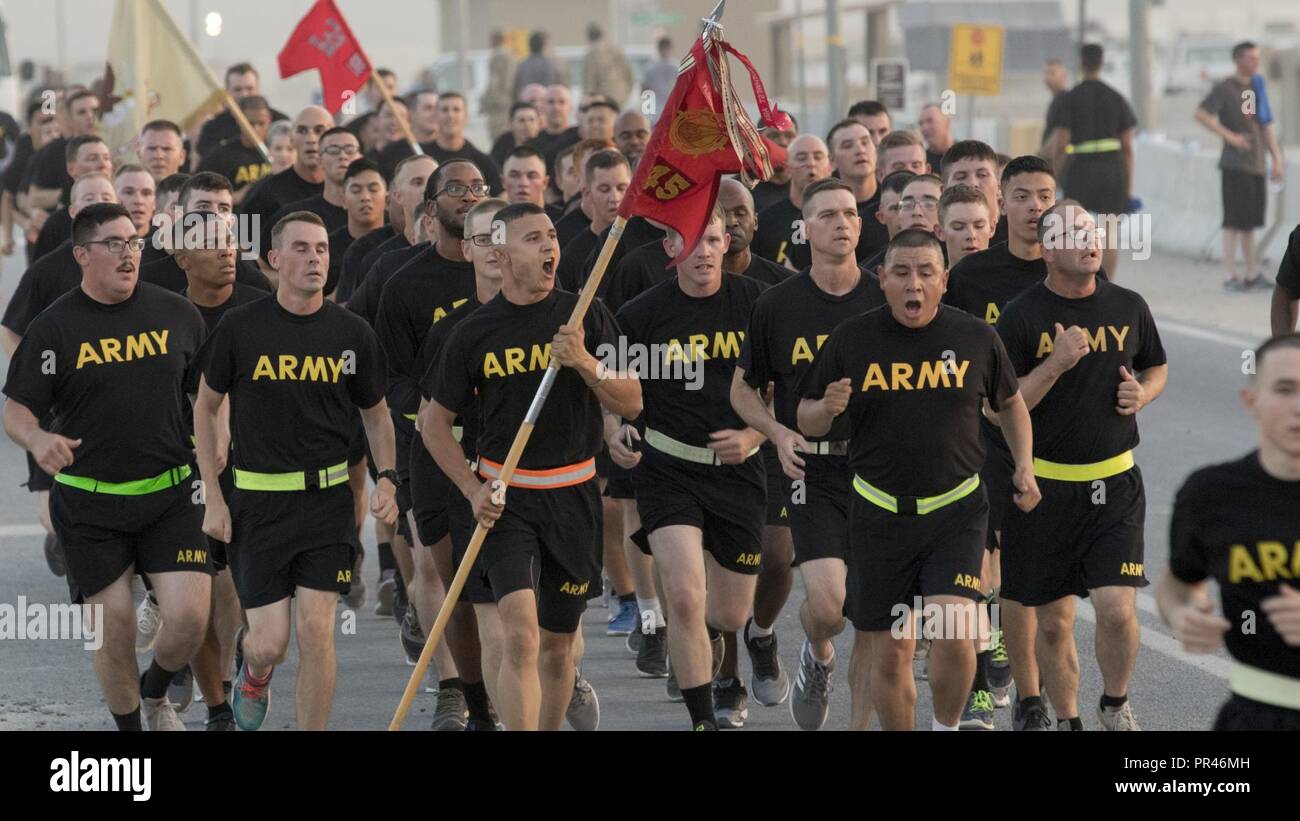 A group of U.S. Army Soldiers approach the finish line at a 5K run to ...