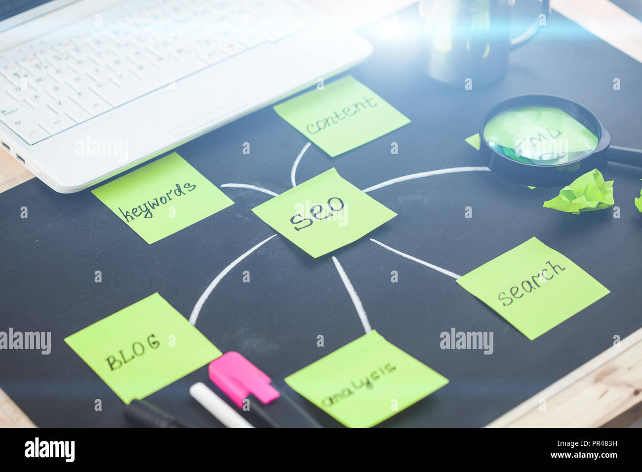 SEO Search engine optimization concept Paper notes on a dark background ...