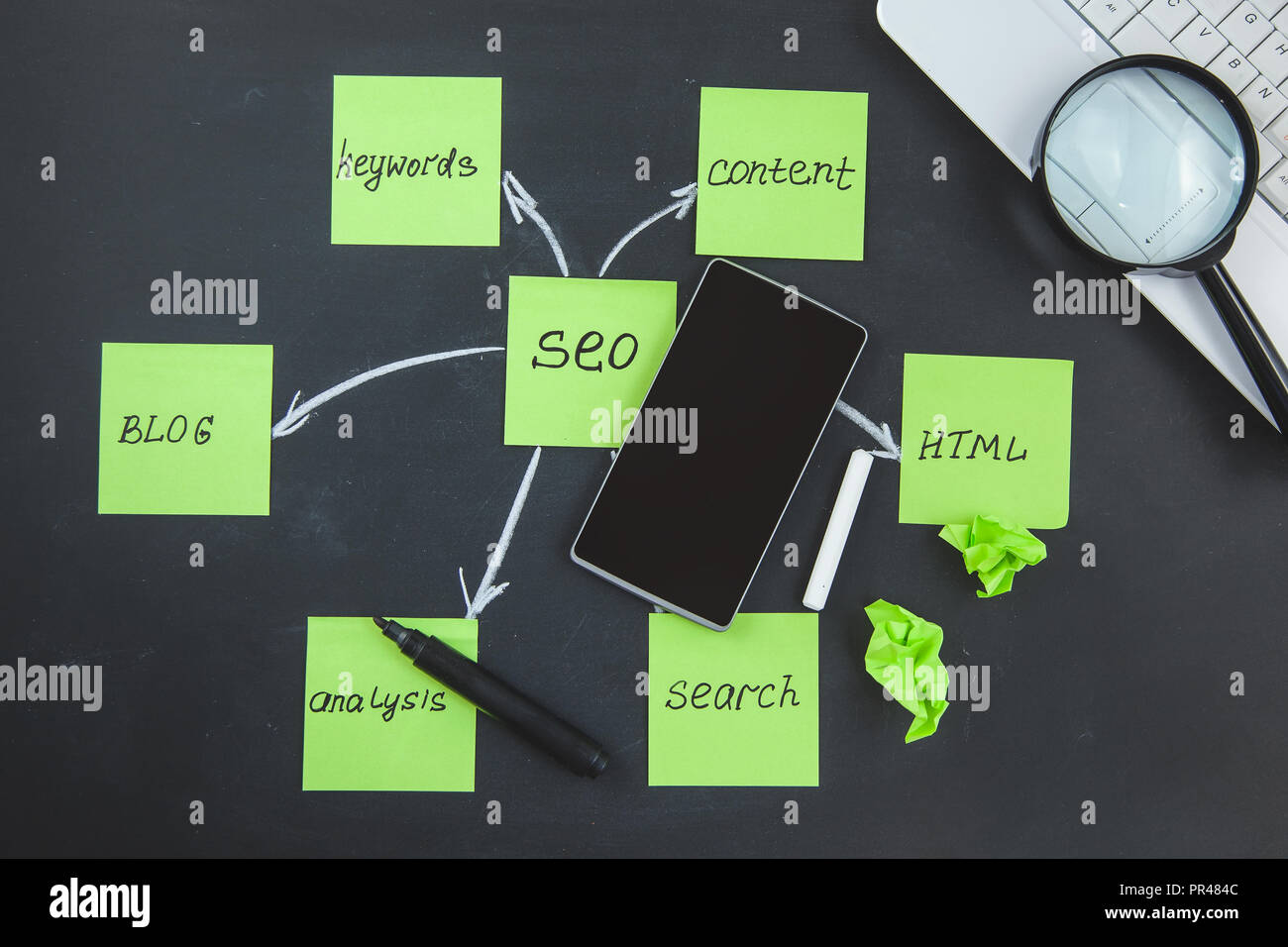 SEO Search engine optimization concept Paper notes on a dark background ...