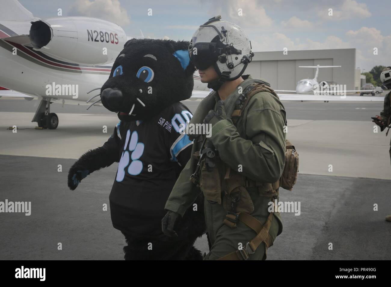 Sir Purr, the mascot for the Charlotte Panthers, walks with Sgt ...