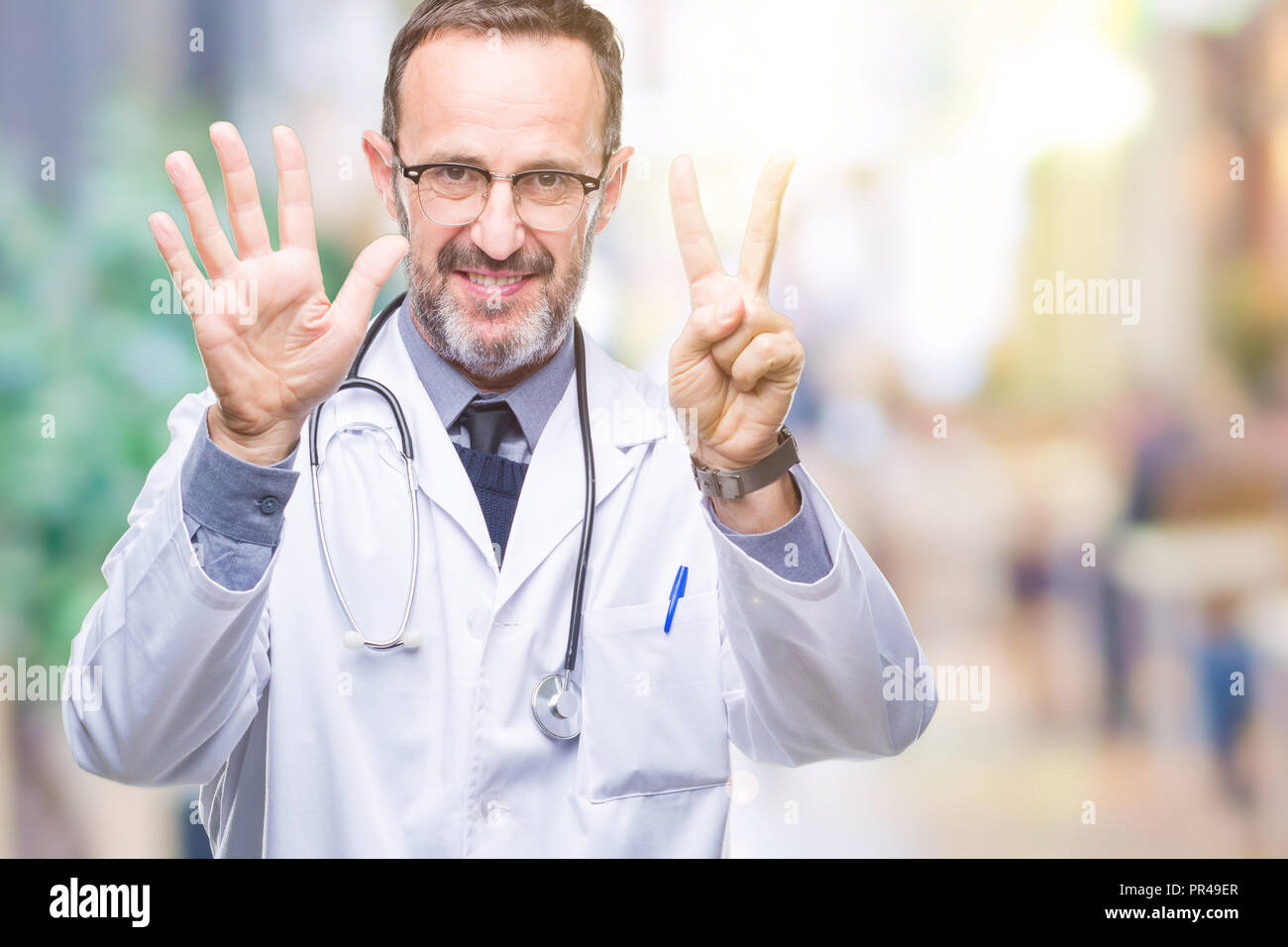 Middle age senior hoary doctor man wearing medical uniform isolated ...