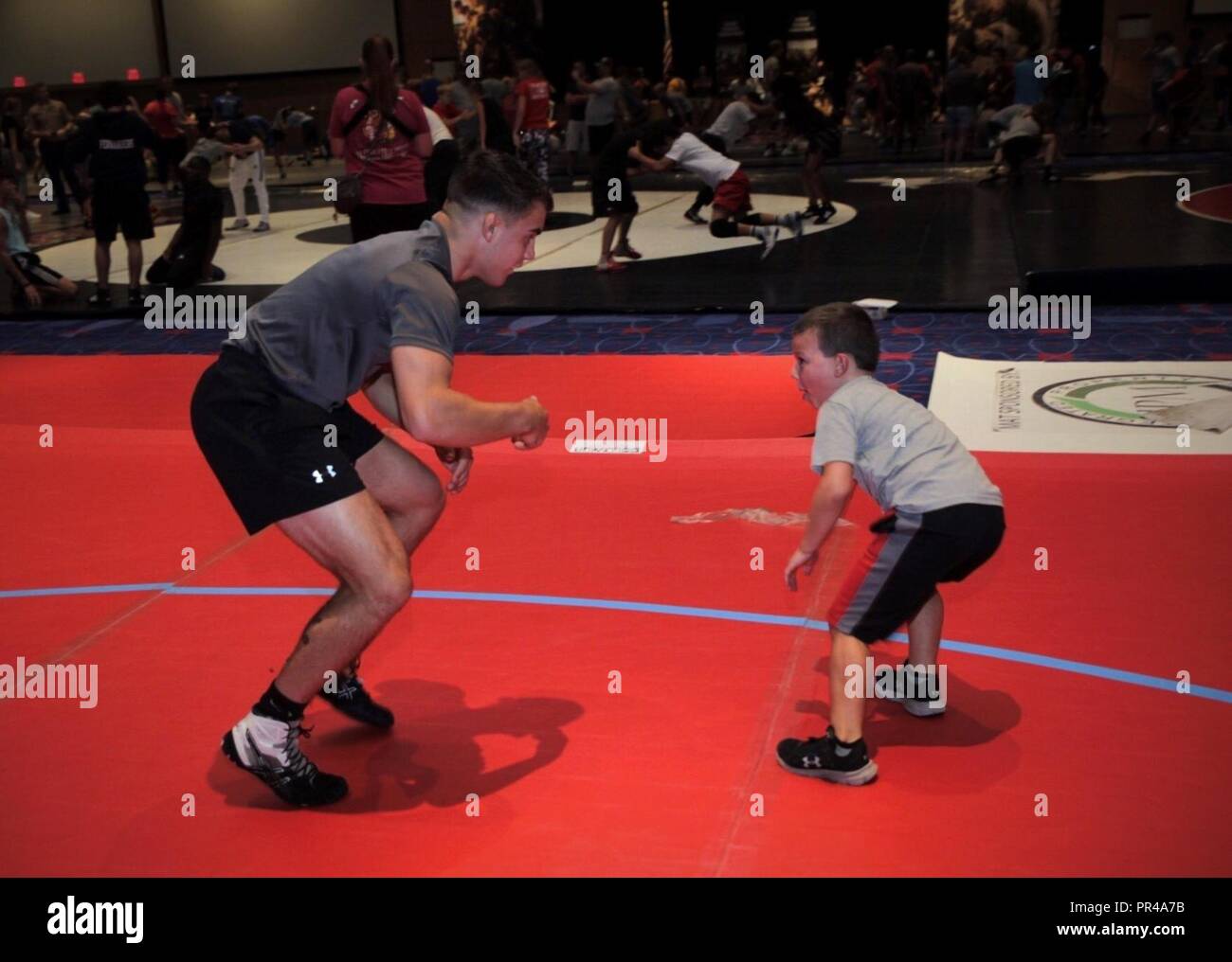 Marine Cpl. Jacob Snoddy helps a young athlete practice techniques ...