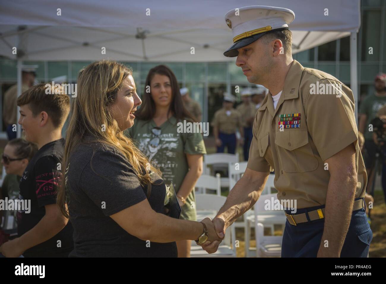 U.S. Marines greet the Dudley family during a wreath laying ceremony at ...