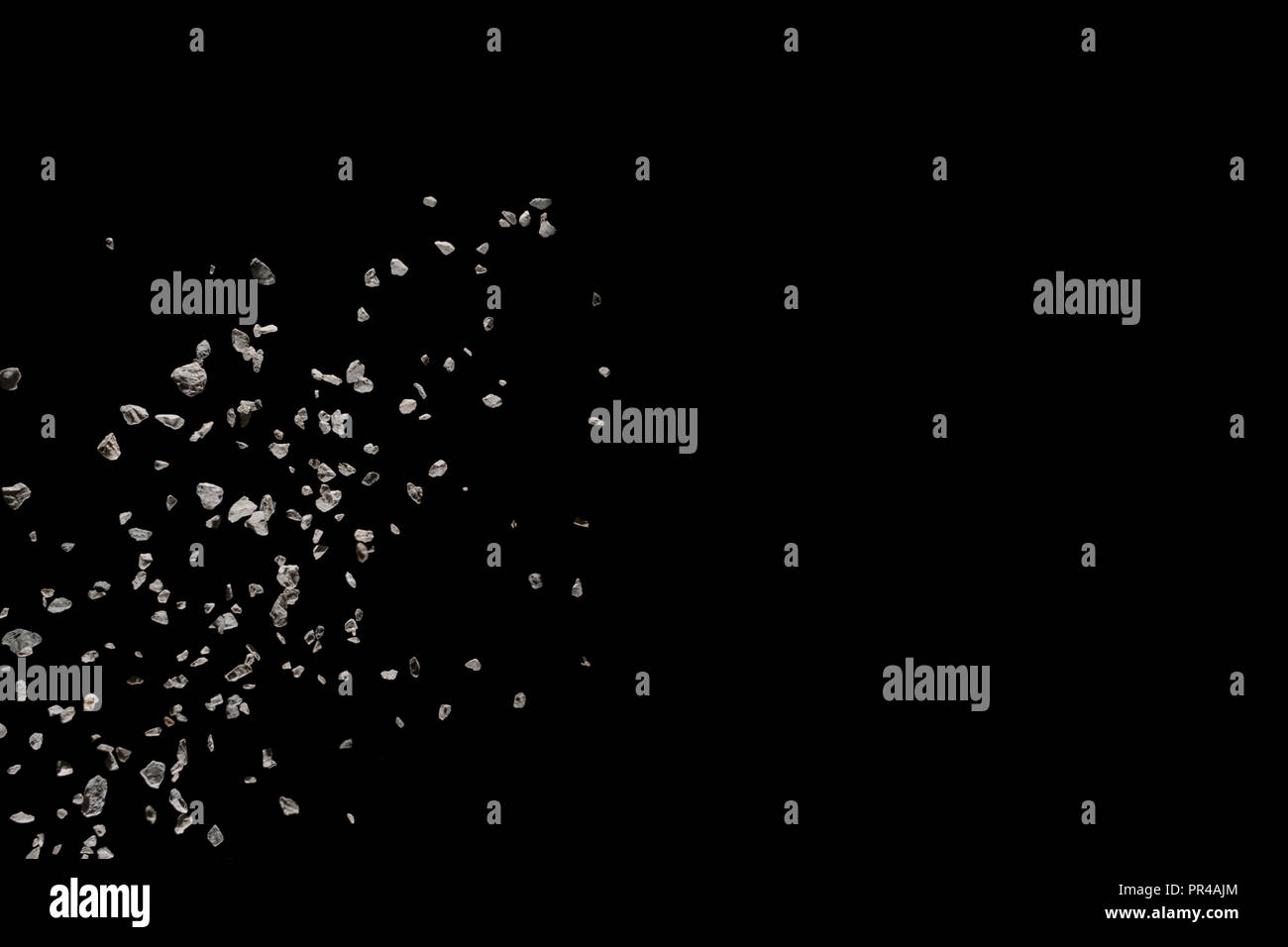 Split debris of stone exploding against black background Stock Photo ...