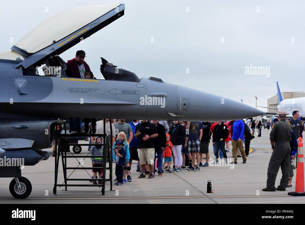 Airshow guests stand in line to see the cockpit of an F-16 Fighting ...