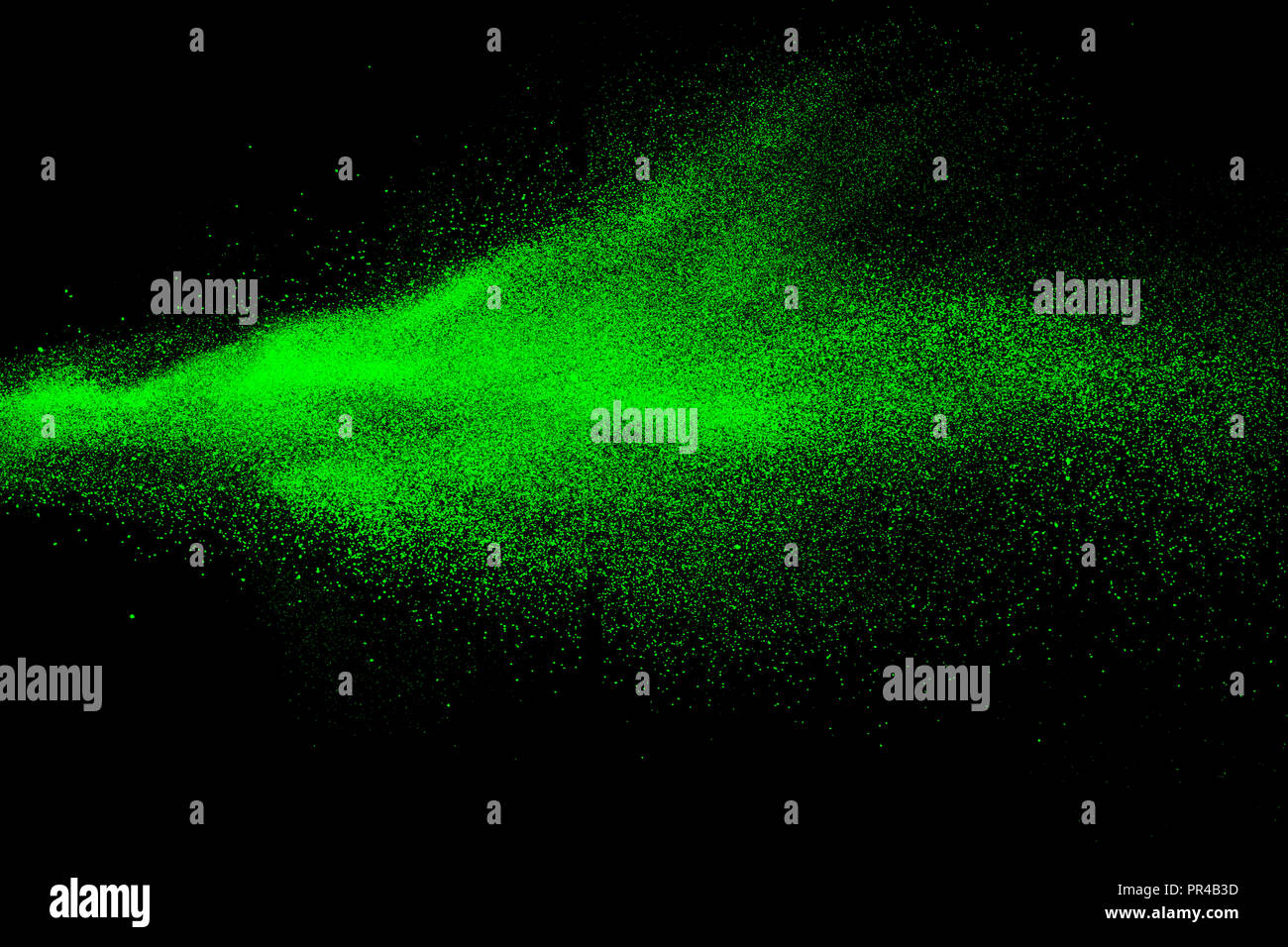 Green color powder explosion cloud on black background.Green dust ...