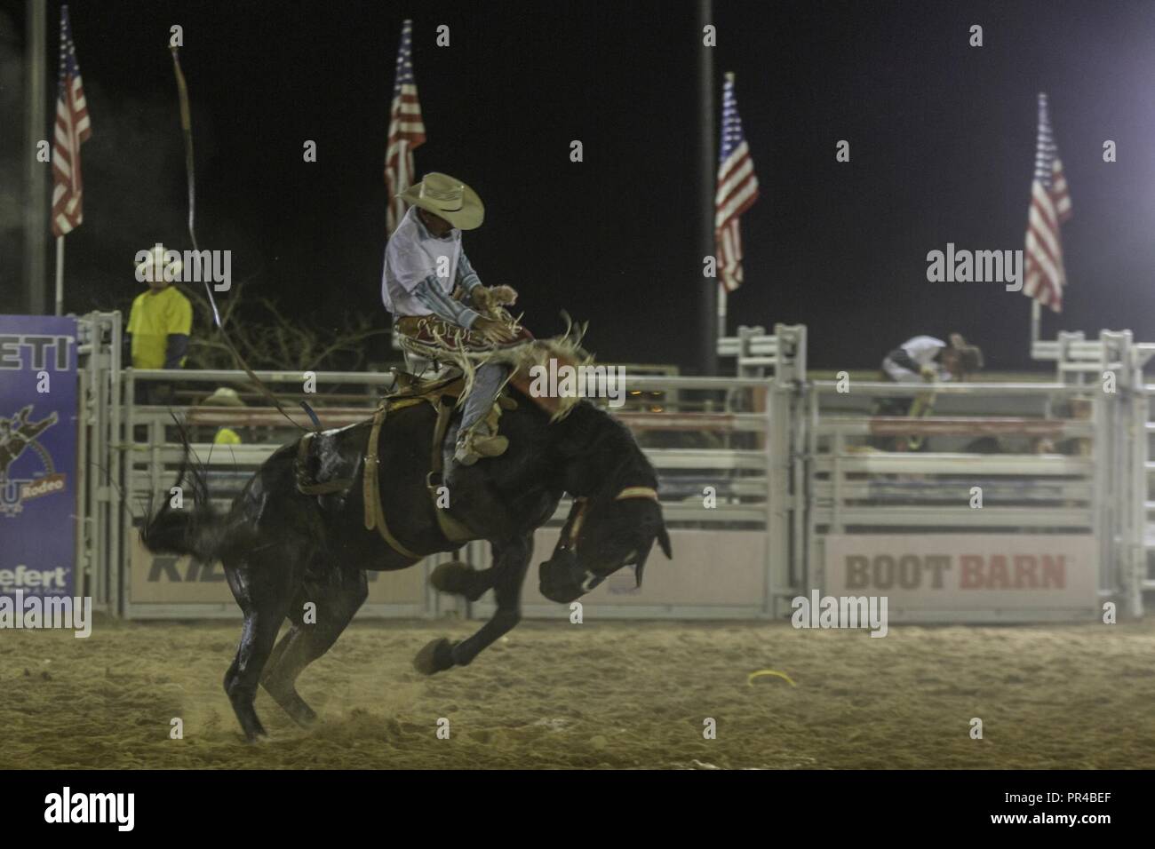 Flying U bronco rider holds on desperately with one hand as his horse ...