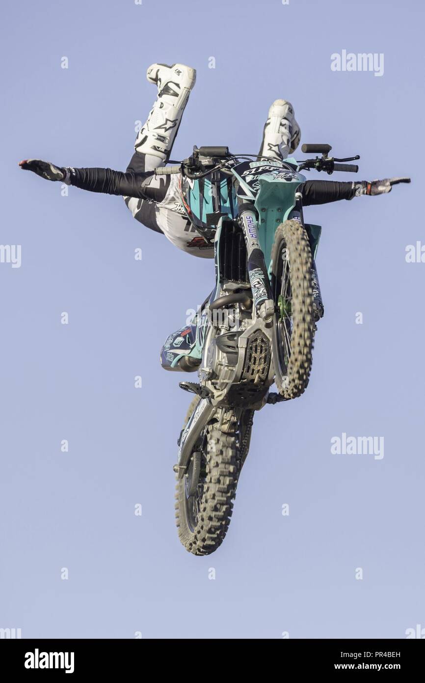 A rider and his dirt bike come apart as the rider pulls his hands and ...