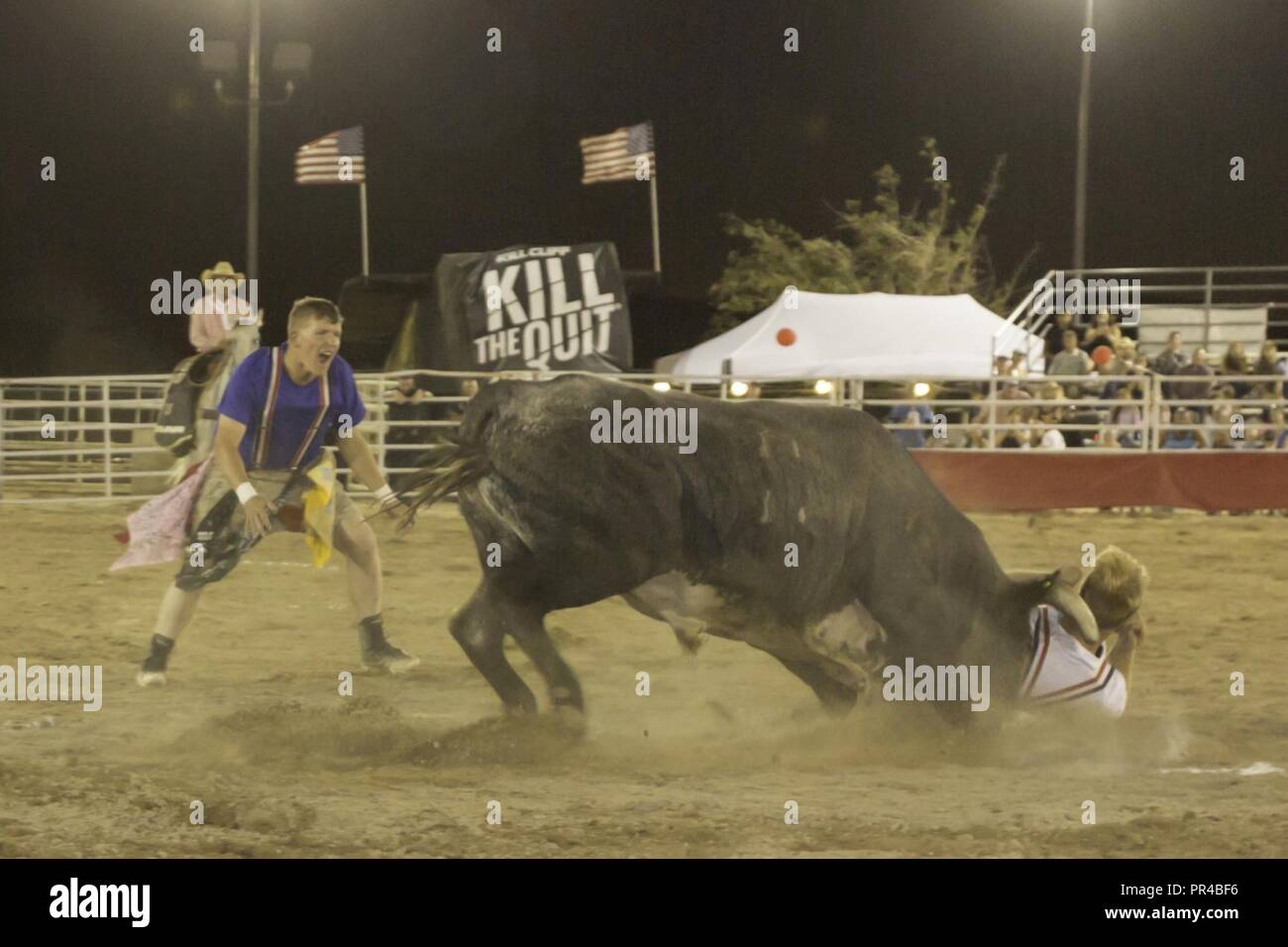 A bull strikes an arena competitor during the "Ring of Fire ...