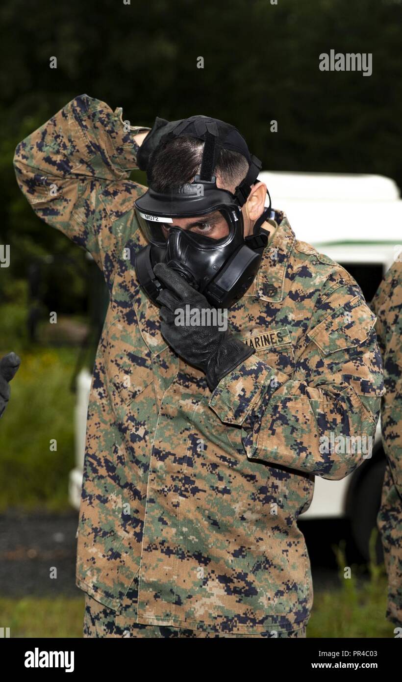 A U.S. Marine with Marine Corps Embassy Security Guard (MCESG) puts on ...