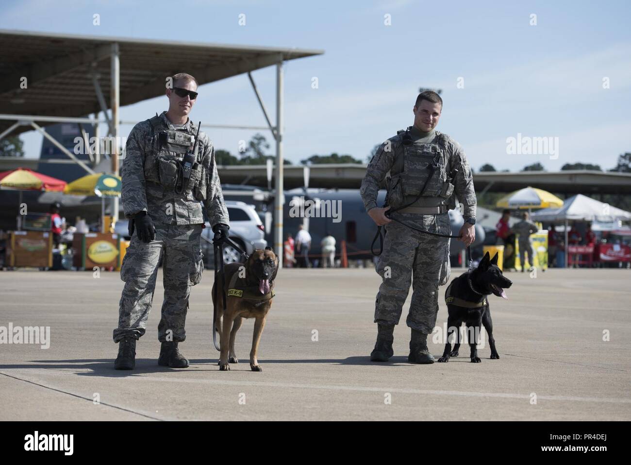 Two security forces dog handlers pose for a picture, Sept. 8, 2018, at ...