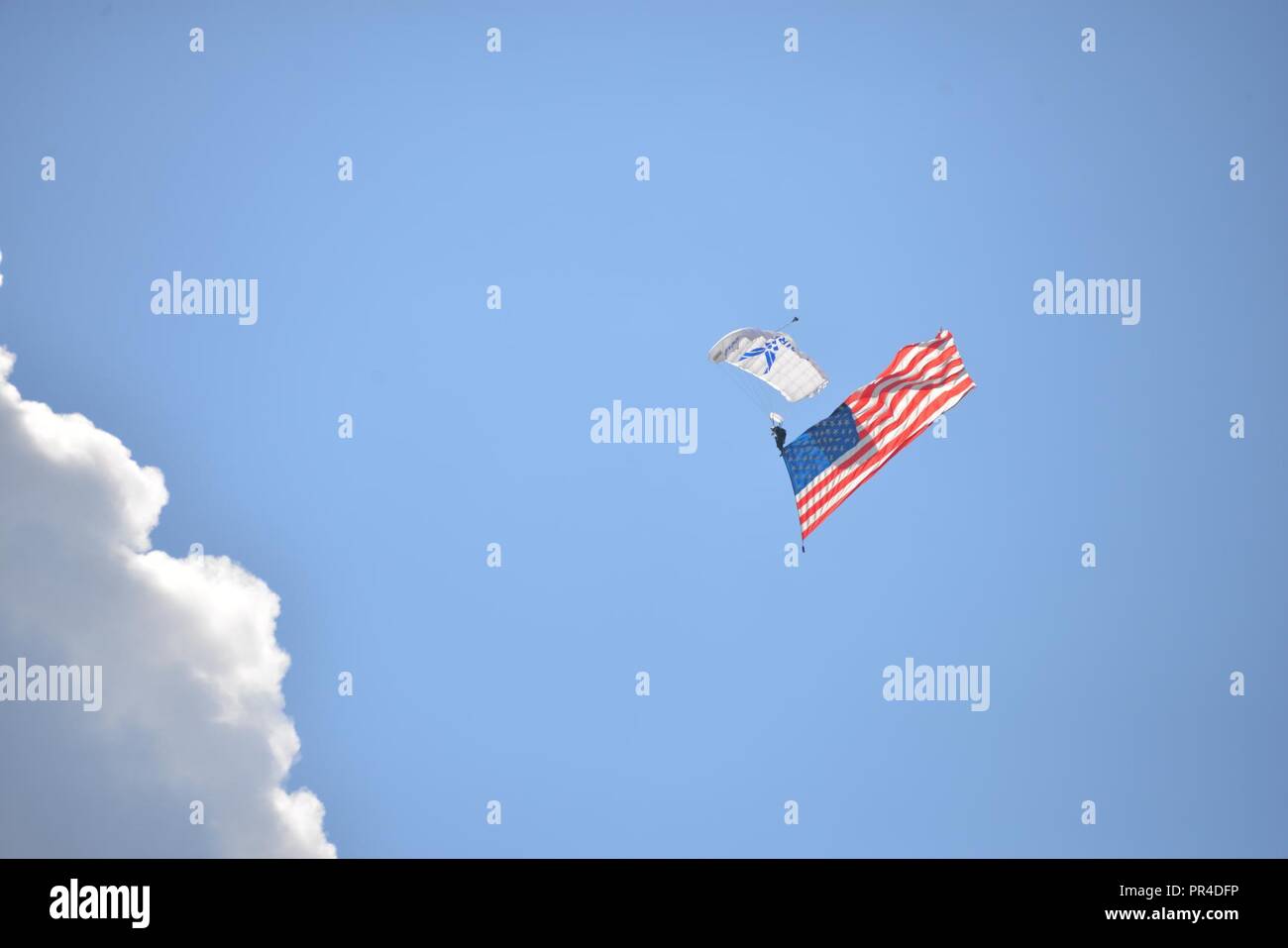 The Air Force Wings of Blue parachute team carries the flag for the ...