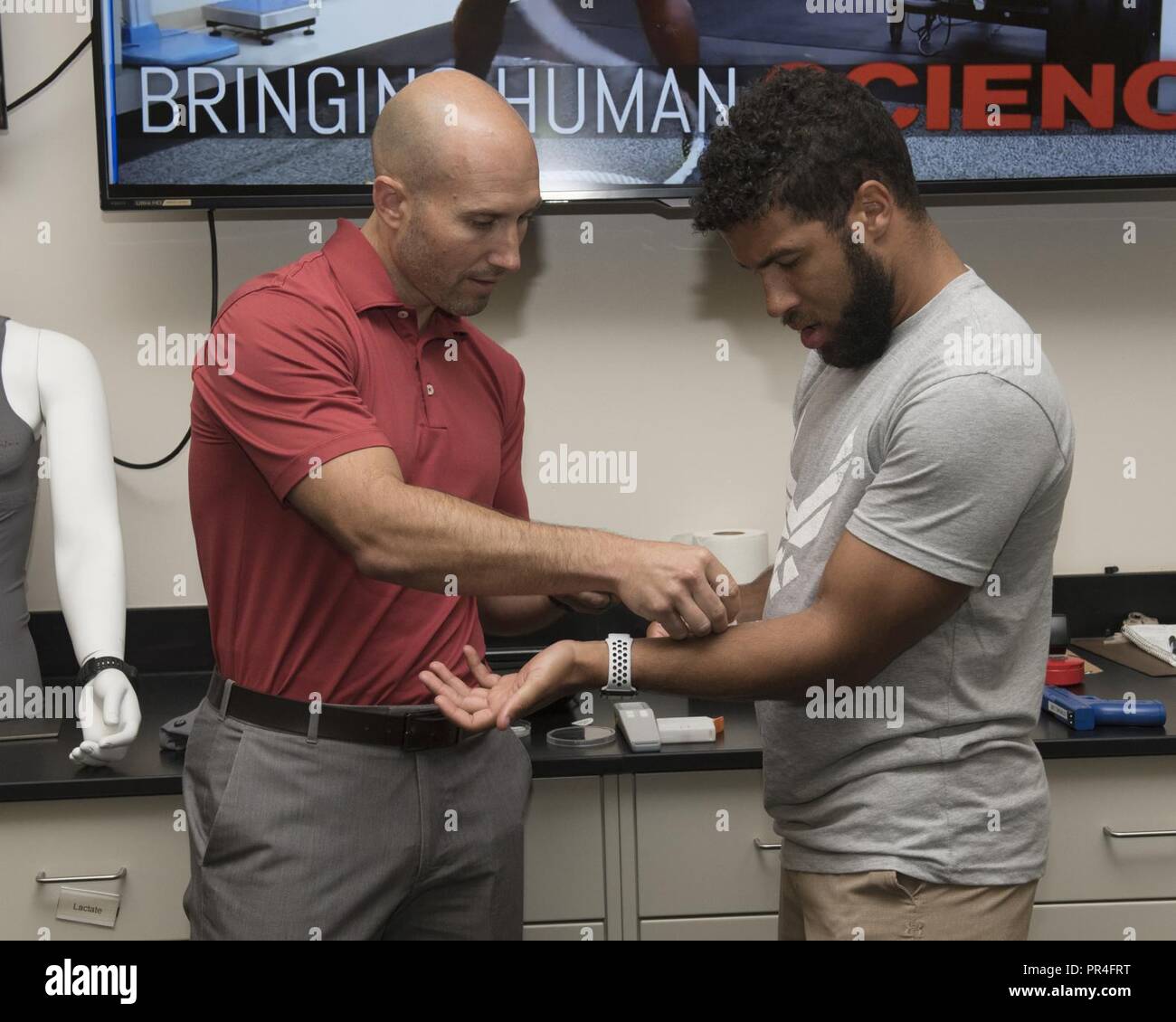 Dr. Adam Strang, 711th Human Performance Wing scientist applies a sweat ...