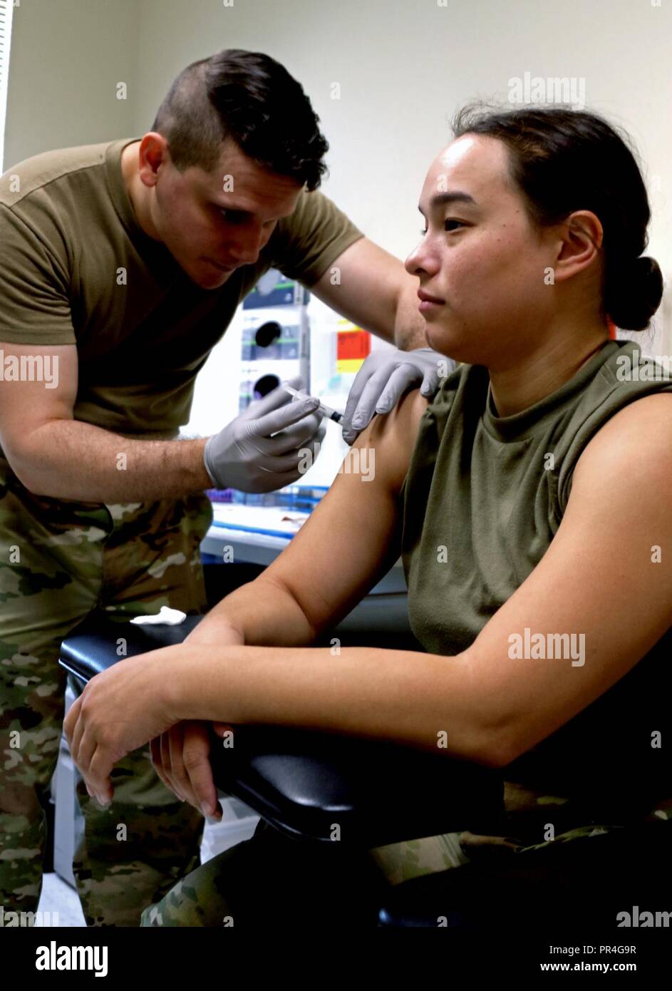 A Fort Drum Soldier administers a vaccine to 2nd Lt. Angela Hartless of ...