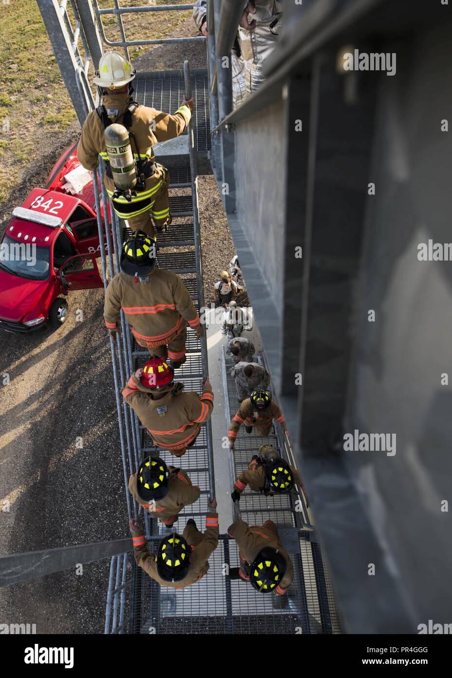 Firefighters with the 5th Civil Engineer Squadron climb stairs at Minot ...