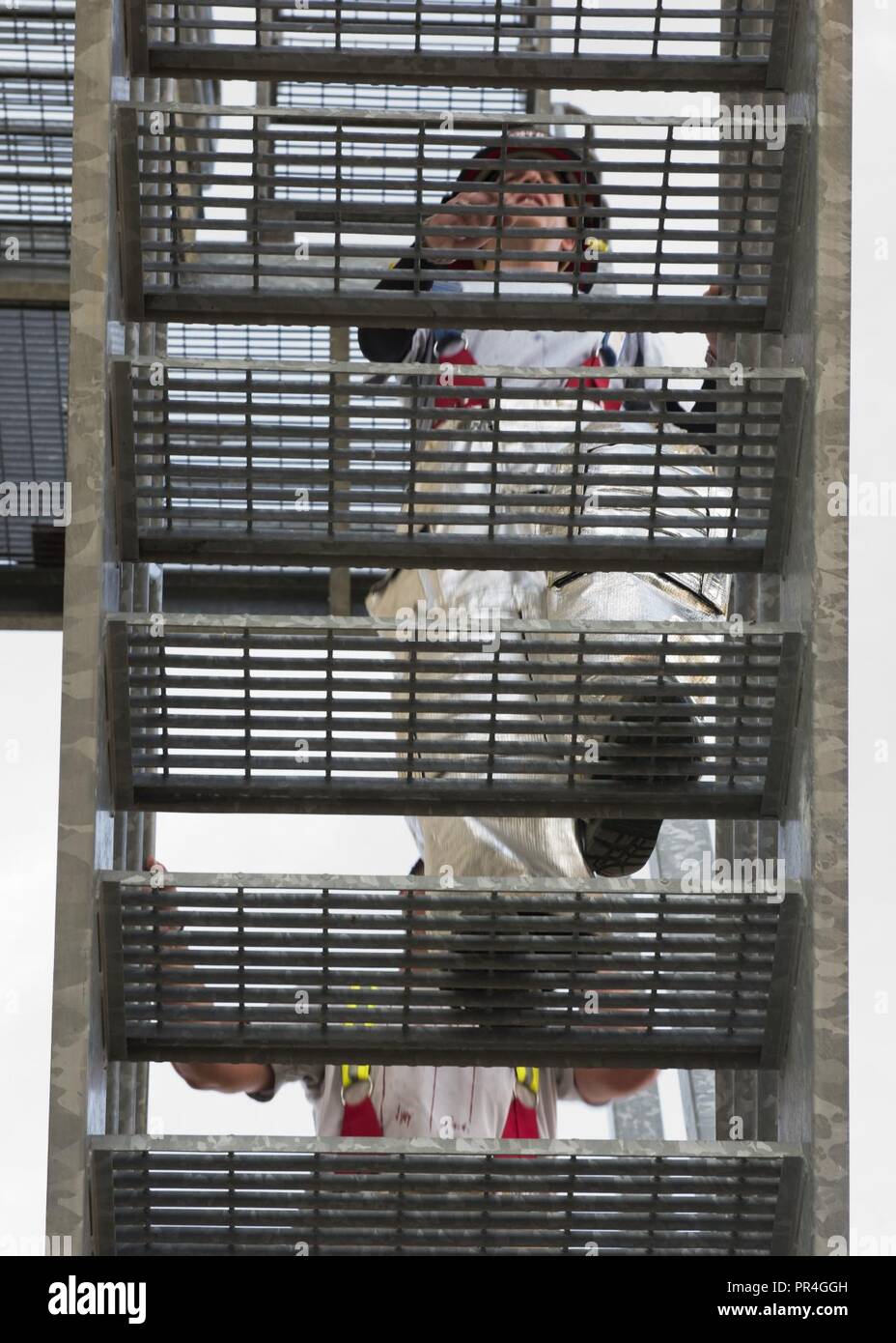 Firefighters with the 5th Civil Engineer Squadron climb stairs at Minot ...