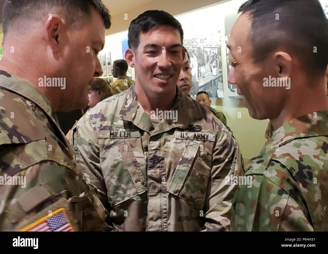 Staff Sgt. Lucas Miller (center) translates a conversation between Maj ...