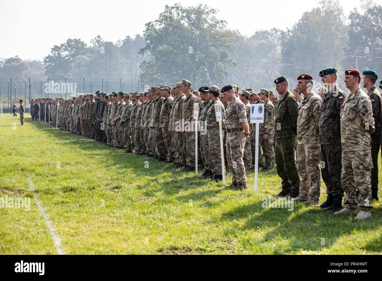 Soldiers from 14 nations stand together in formation during the closing ...