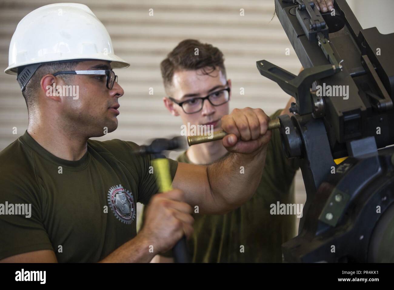 Lance Cpl. Dario Covarrubias hammers a part into place during the ...