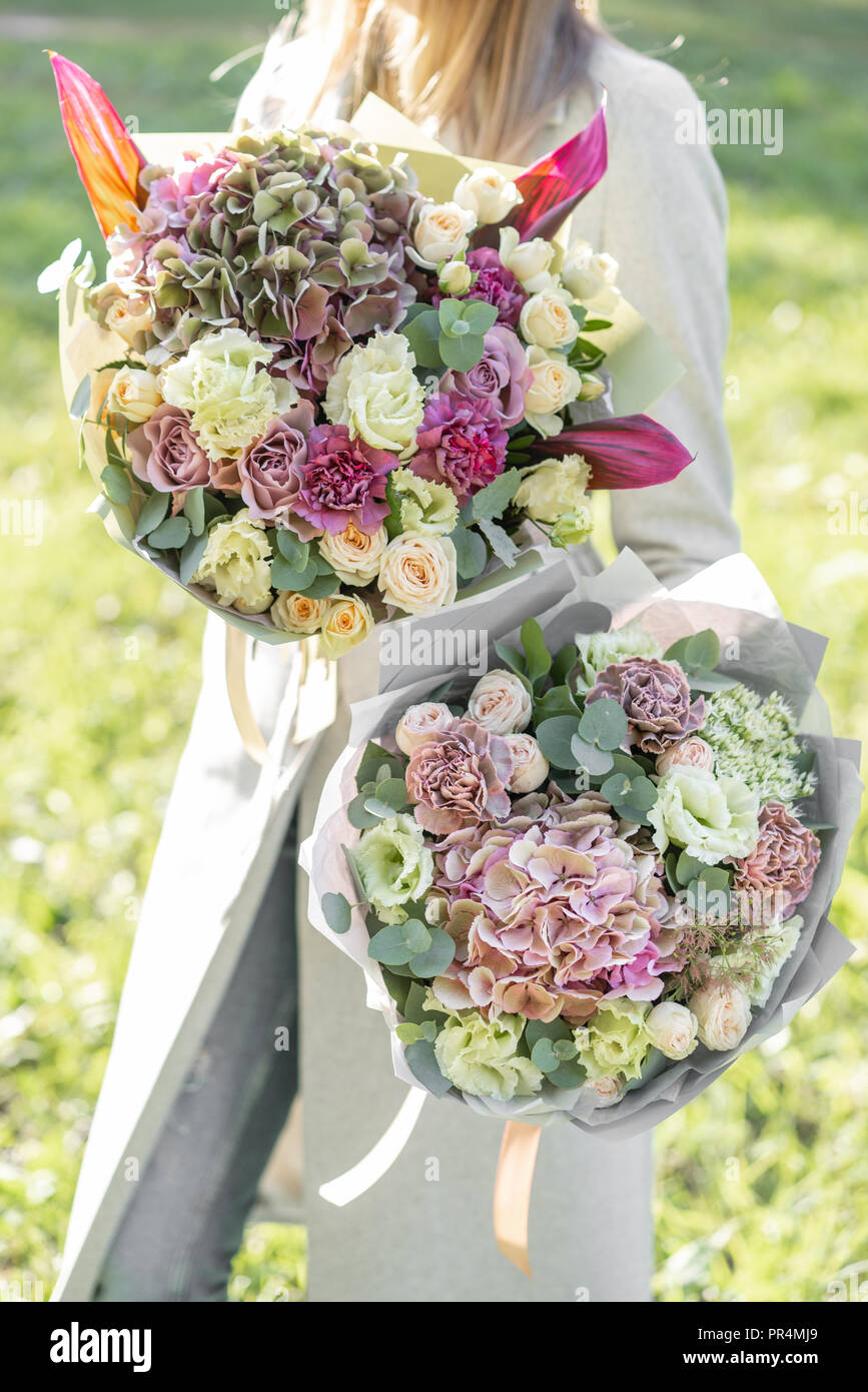 two beautiful spring bouquet. Young girl holding a flowers arrangements ...