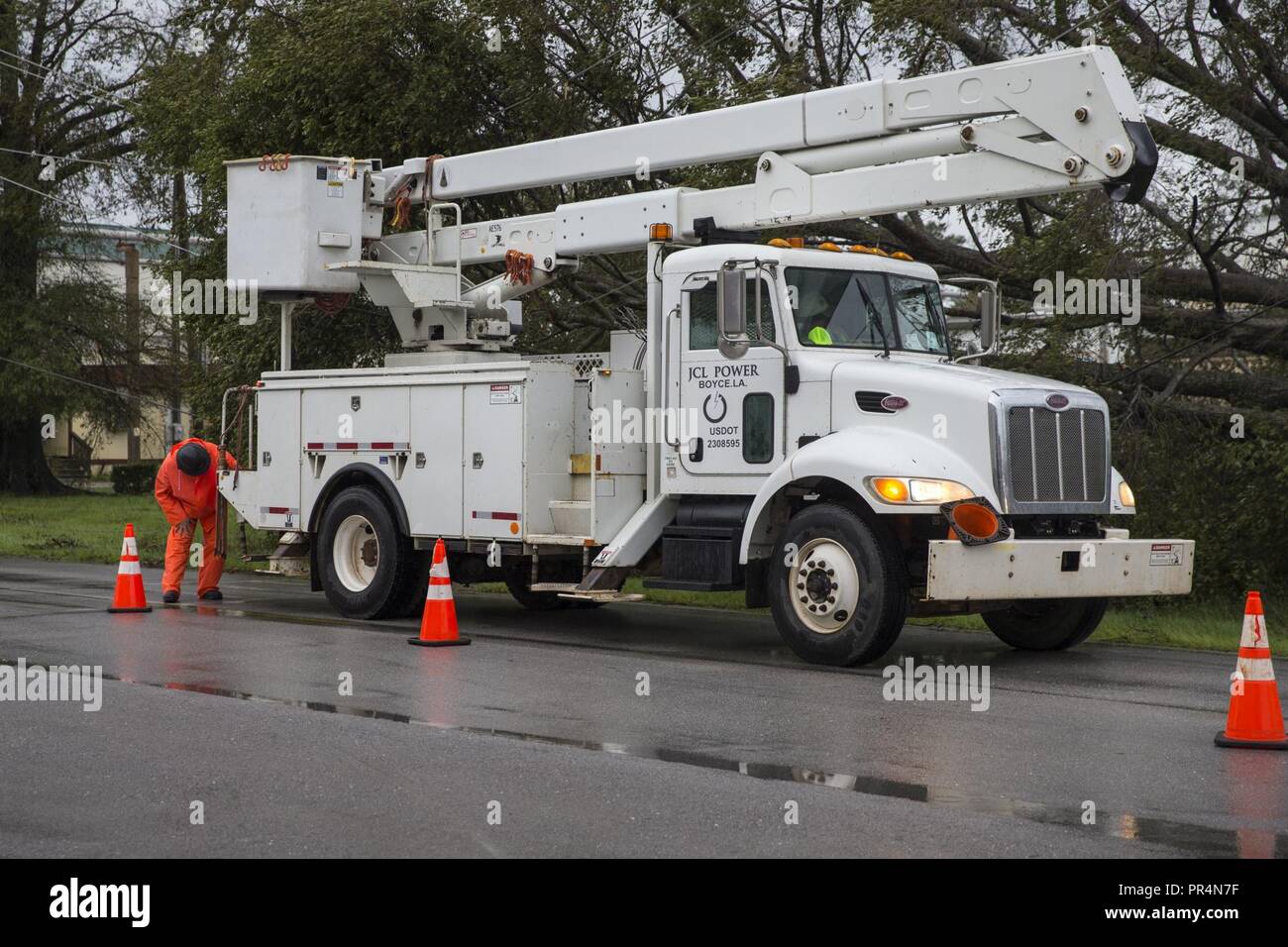 Utility workers with JCL Power Boyce L.A., repair damaged power lines ...