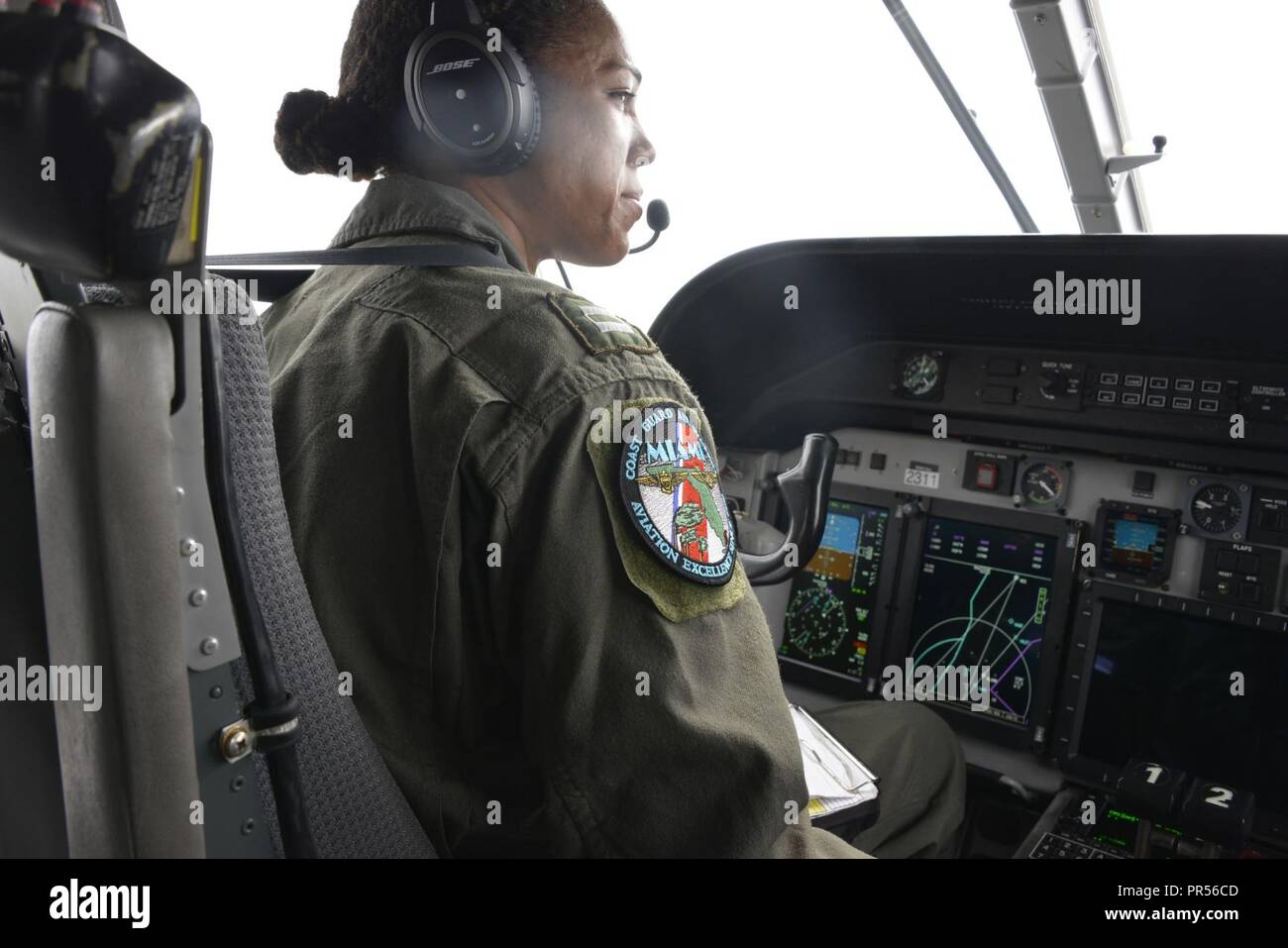 Lt. Ronaqua Russell, a pilot from Coast Guard Air Station Miami, flies ...