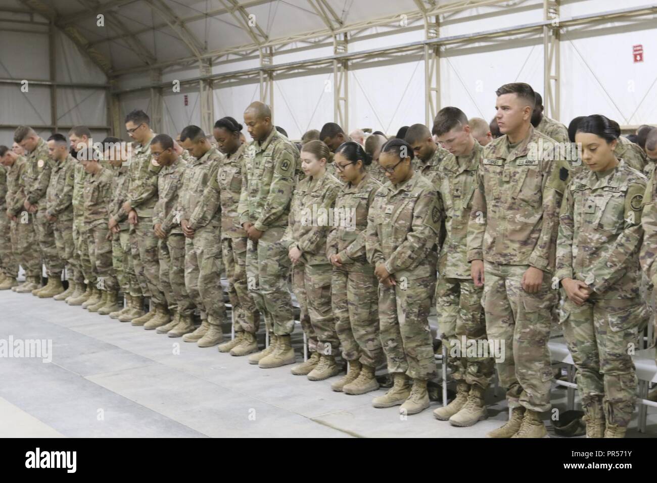 U.S. Army Soldiers, during the benediction at the graduation ceremony ...