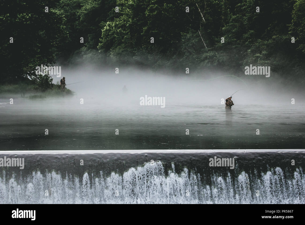 Fly fishing in the fog Stock Photo - Alamy