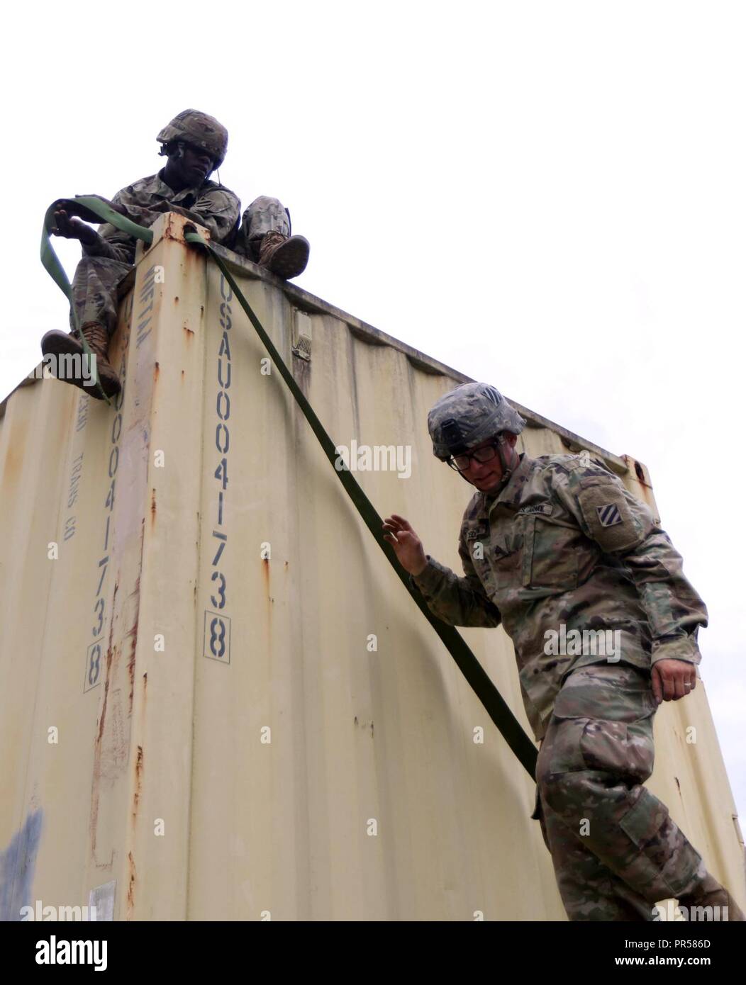Sgt. De’Marquis Tucker attaches a strap to the top of a tricon ...