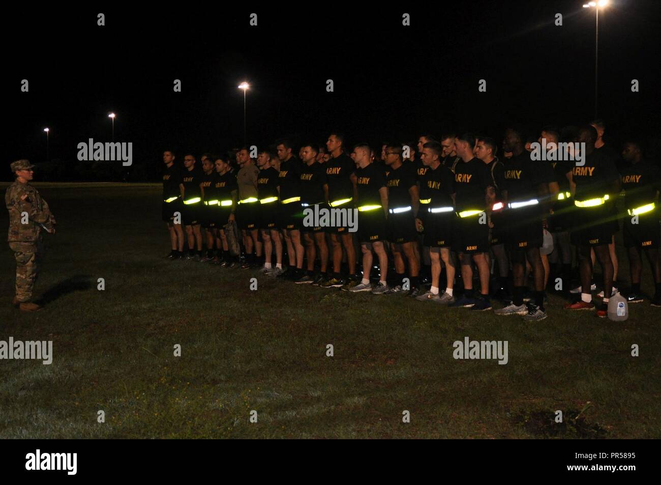 Soldiers line up in formation to receive instructions on how to conduct ...