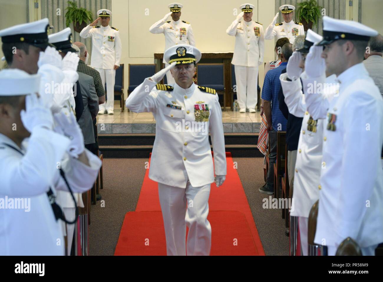 Capt. Robert Wirth, commodore, Submarine Squadron 20, renders a salute ...