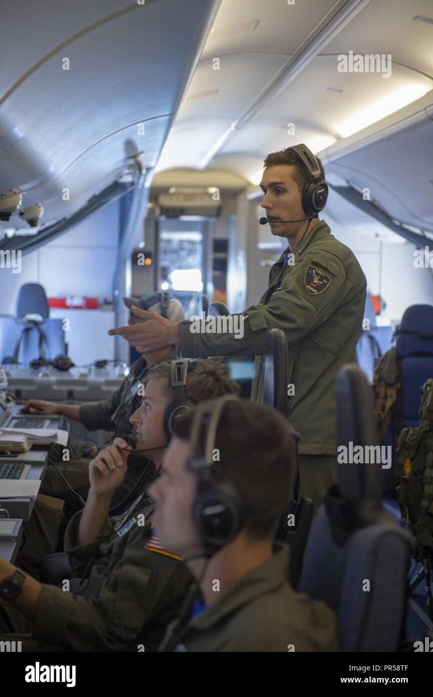 Mission commander Lt. Ken Flannery reviews the footage aboard a P-8A ...