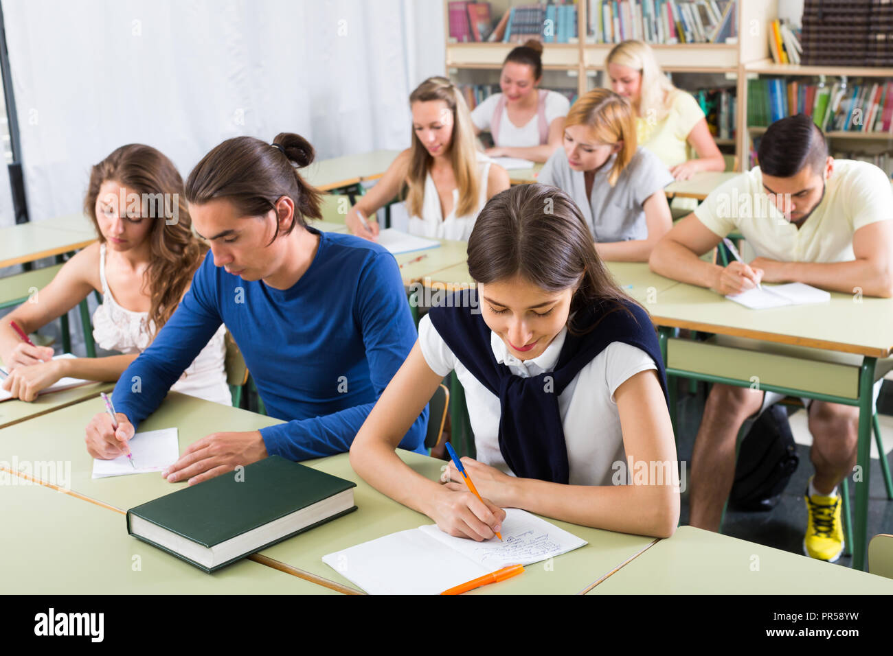 Group of adult students studying together in classroom Stock Photo - Alamy