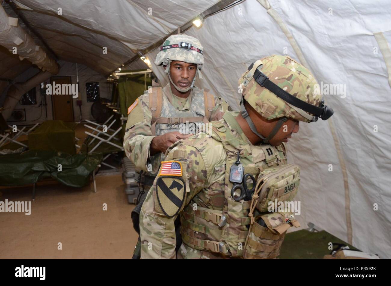 SPC Brian McCoy, U.S. Army Medical Research and Materiel Command, helps ...