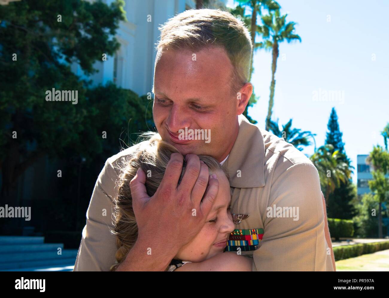 Master-at-Arms Matthew Murphy embraces his daughter at a Sept. 16 chief ...