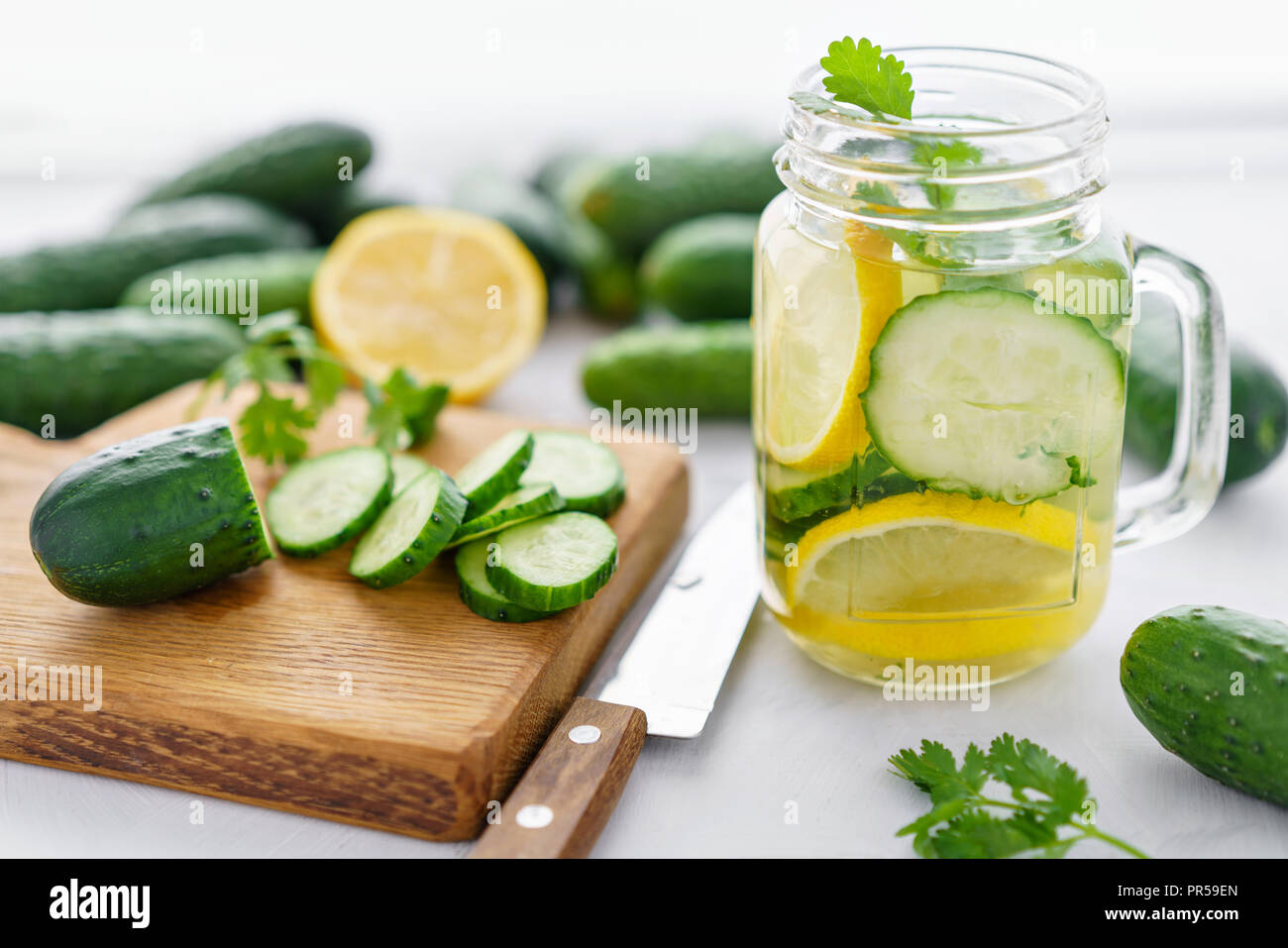 Summer cocktail cucumber lemonade. Refreshing water with cucumber, mint and lemon on grey ...