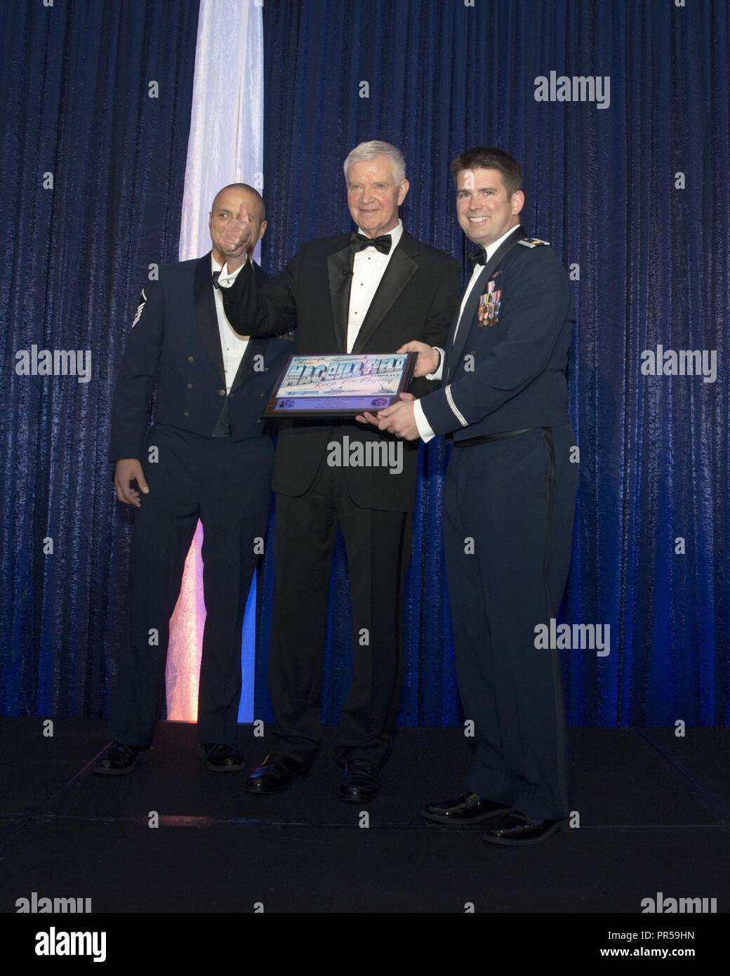 Retired U.S. Air Force General Charles Holland accepts an award at the ...