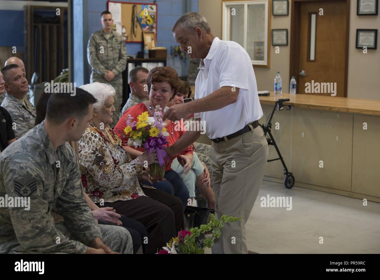 Chief Master Sgt. Brian Pritt (Ret.) (right) hands his mother flowers ...