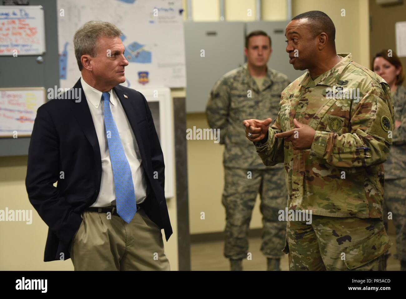 Congressman Buddy Carter listens to U.S. Army Brig. Gen. Reginald Neal ...