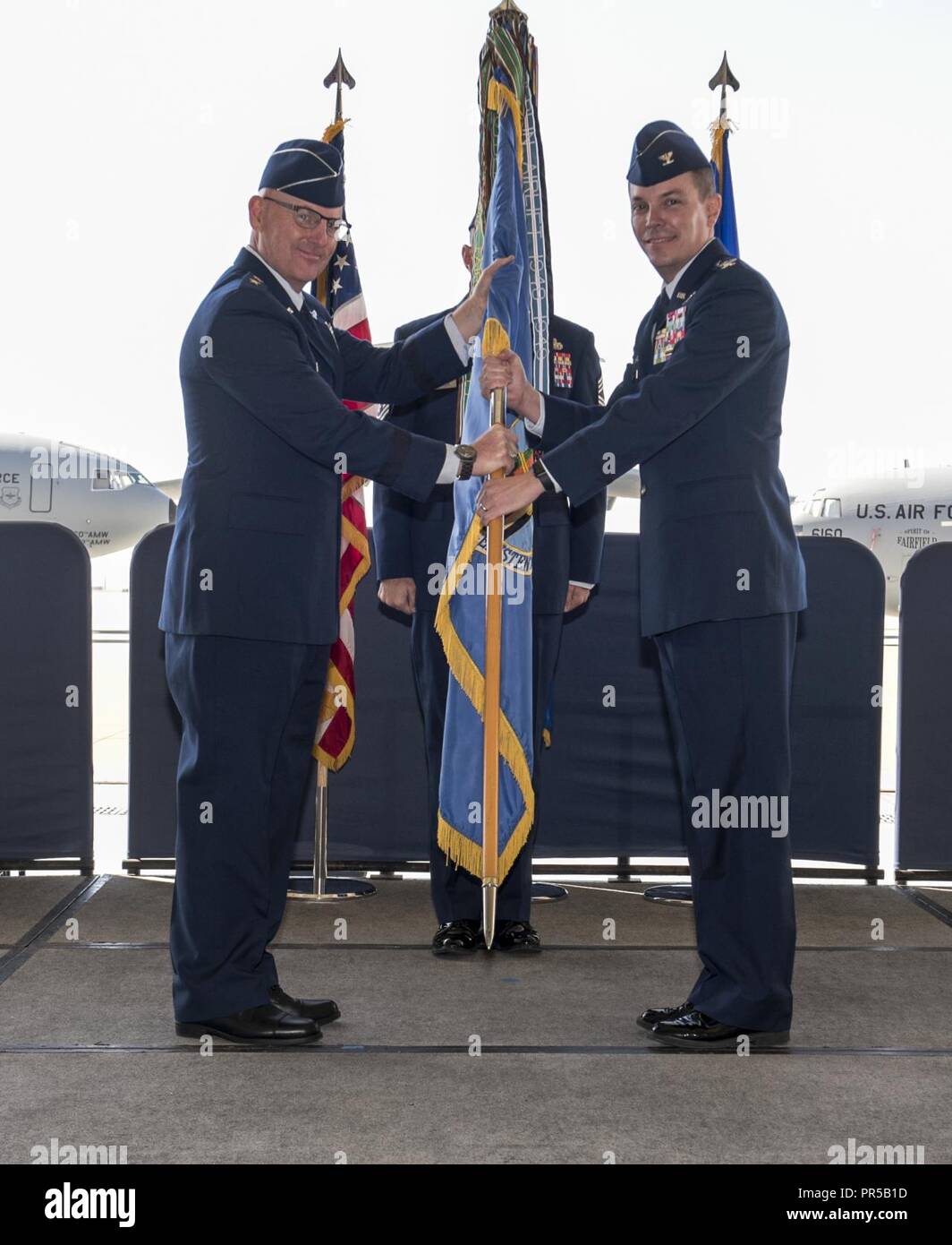 Maj. Gen. Sam Barrett, 18th Air Force commander, passes the guidon to ...