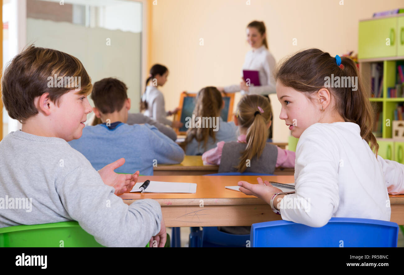Elementary students chatting during class hi-res stock photography and ...