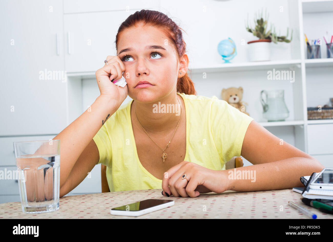 crying teenage girl looking at silent mobile phone indoors Stock Photo ...