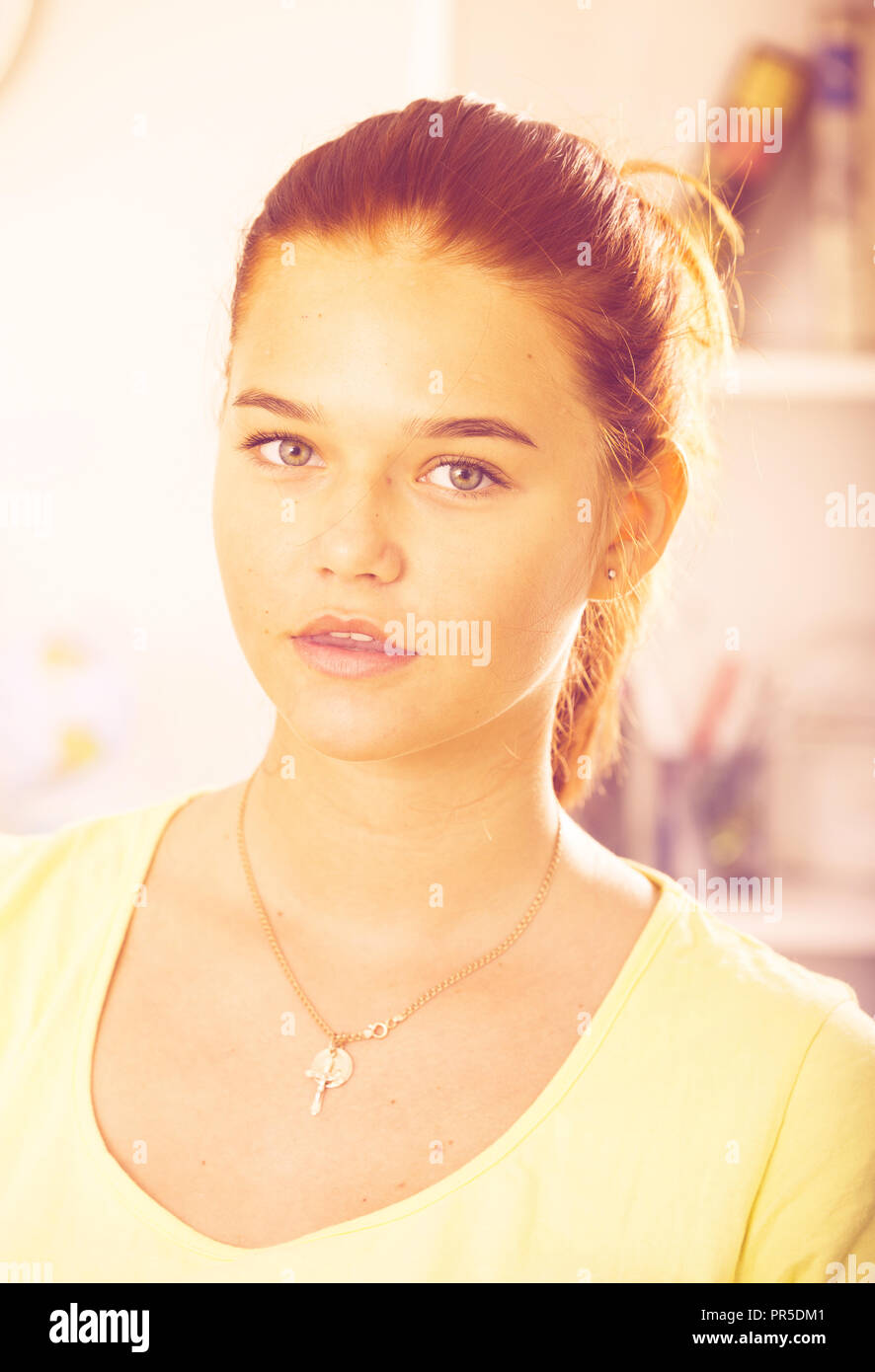 sad female teenager standing indoors and looking depressed Stock Photo ...