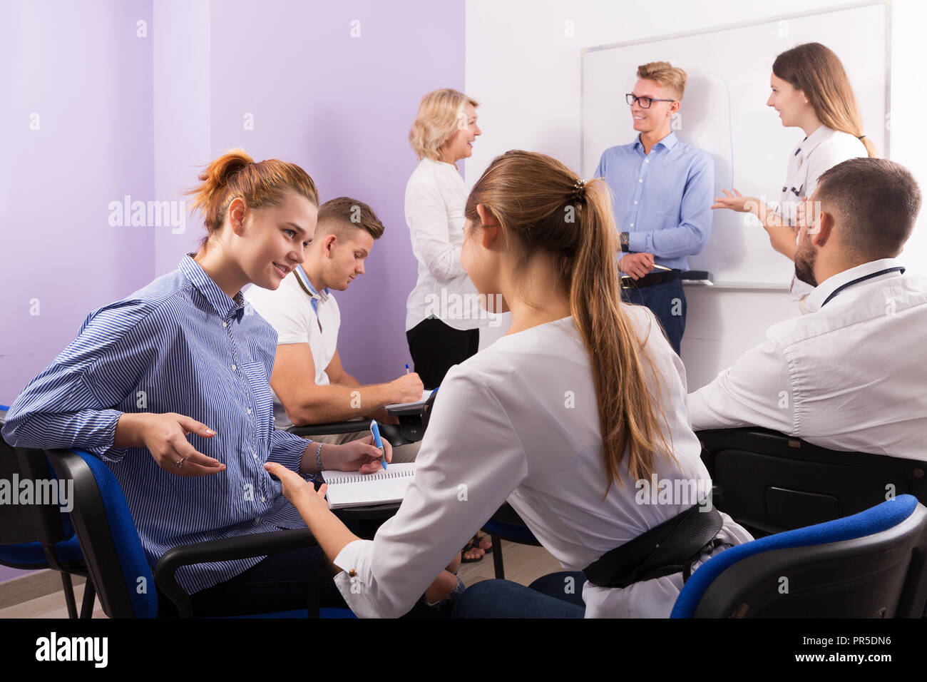 positive students talking with teacher and with each other on break ...