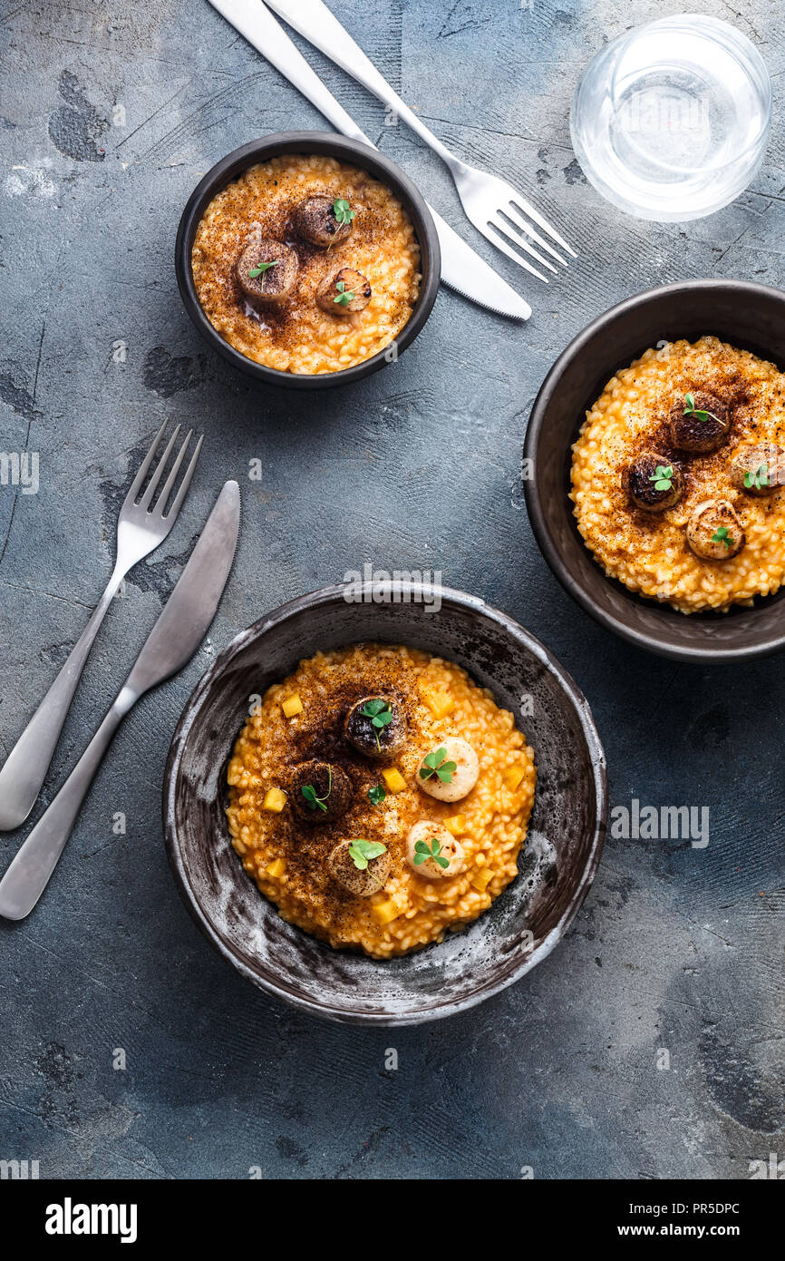 Three risotto bowl on stone background, top view Stock Photo - Alamy