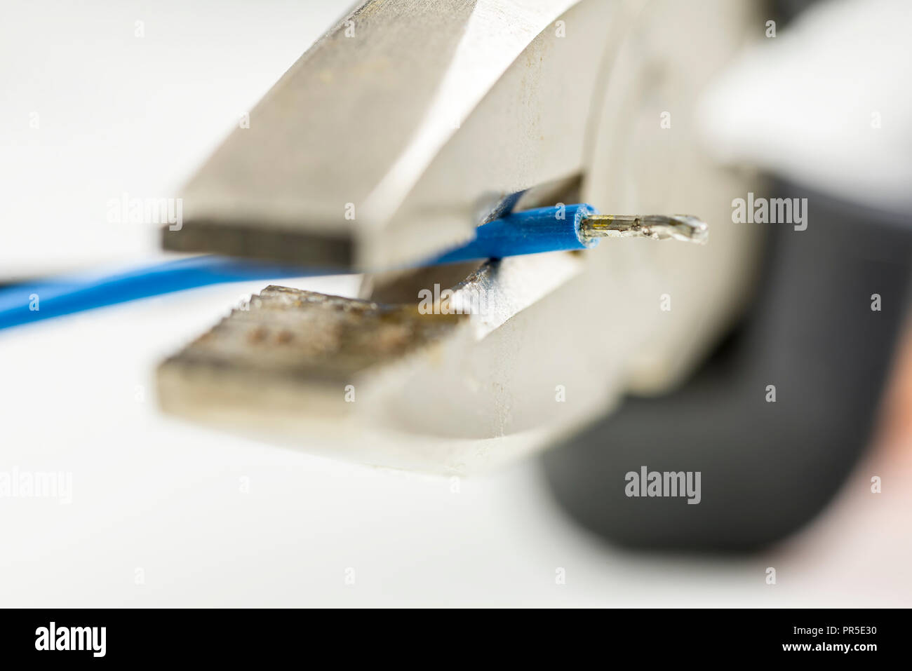 Closeup of pliers cutting electrical cable Stock Photo - Alamy