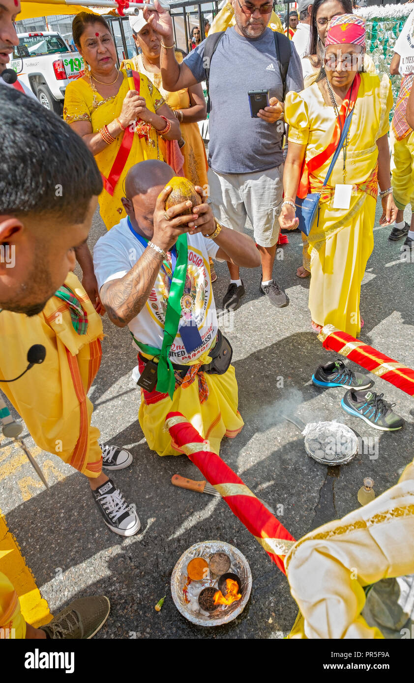 iA hindu man breaking a coconut n South Richmond Hill, Queens, New York ...